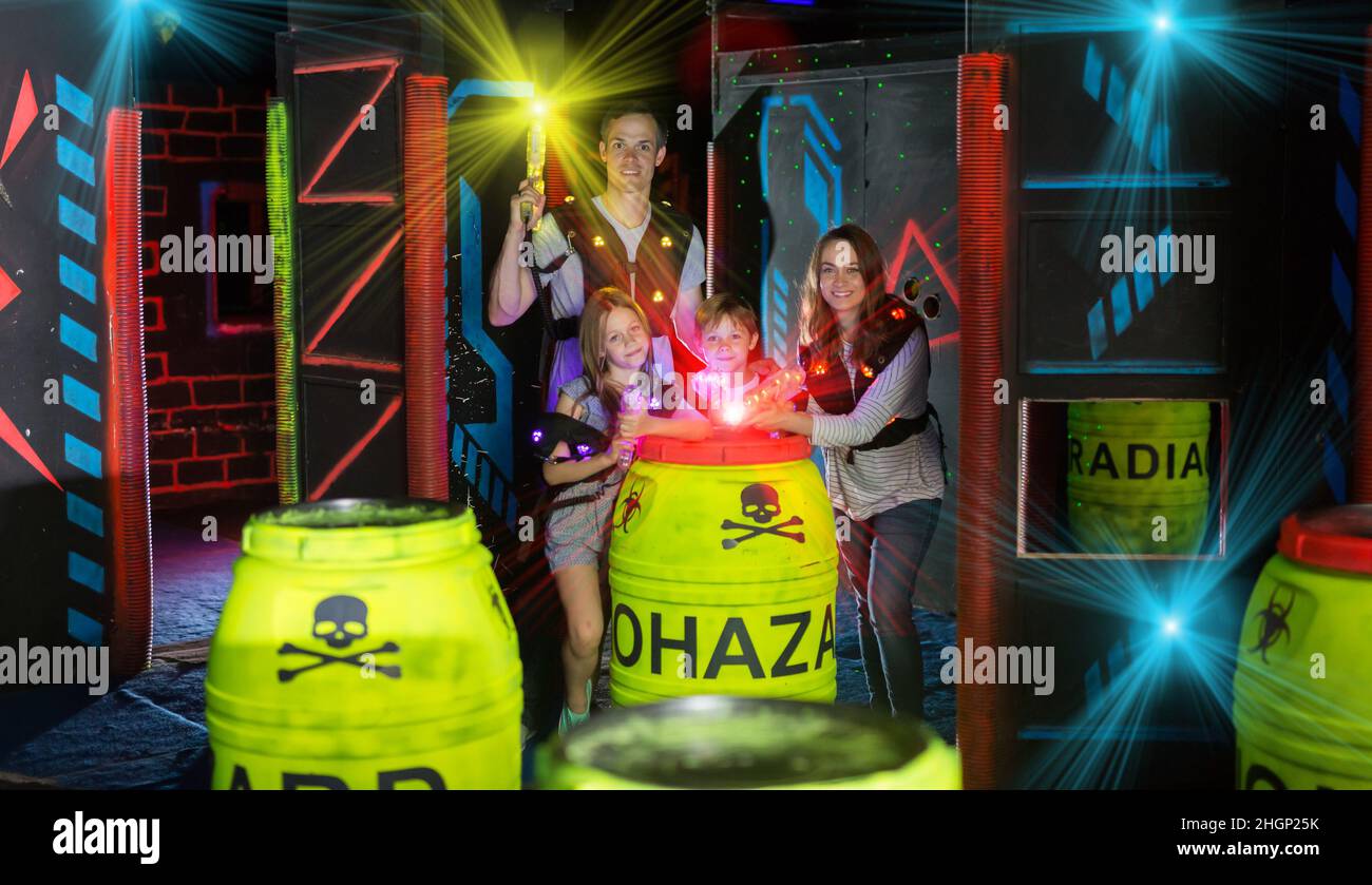 Kids and parents in beams during laser tag game Stock Photo - Alamy