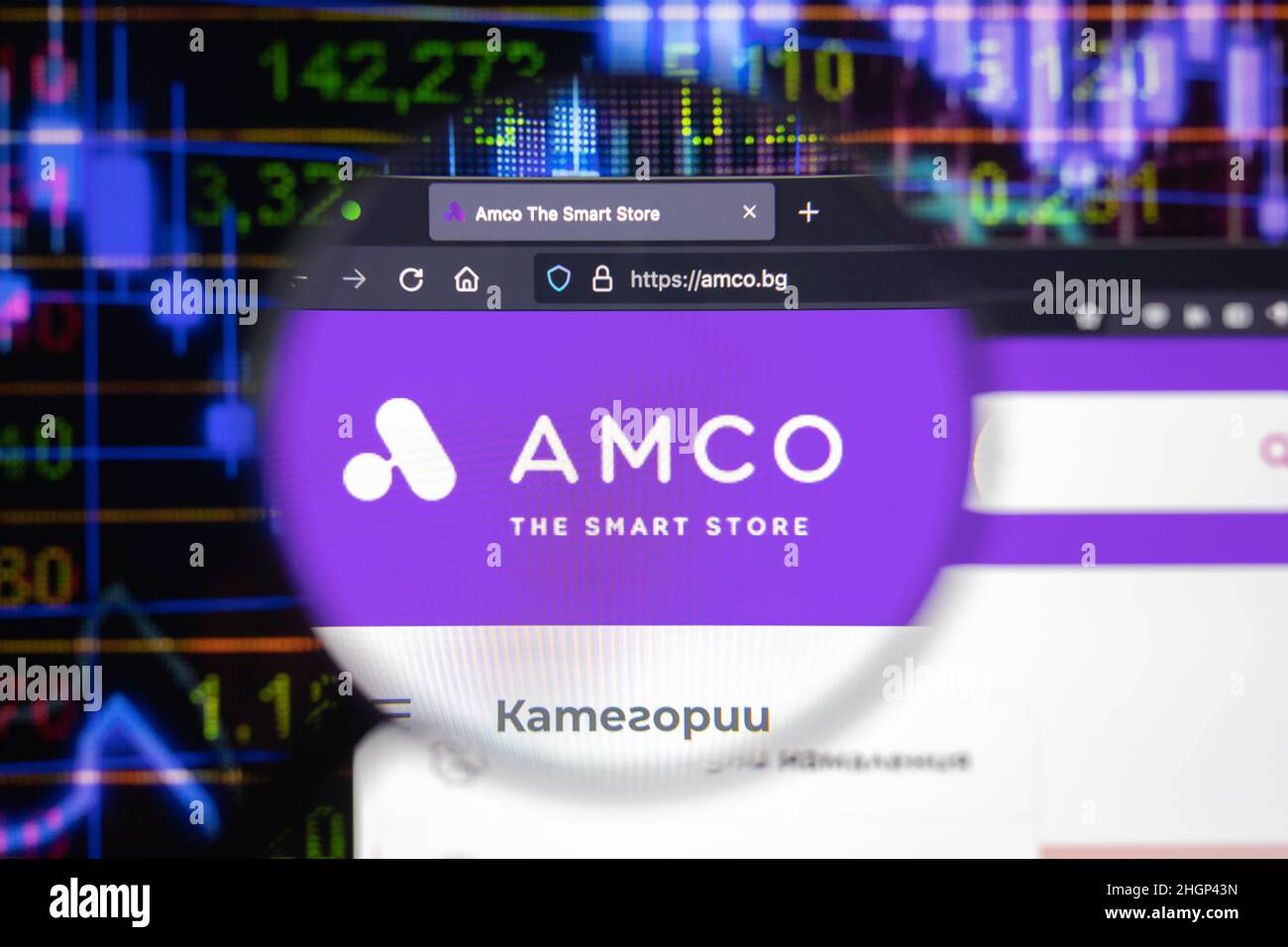 AMCO company logo on a website with blurry stock market developments in ...
