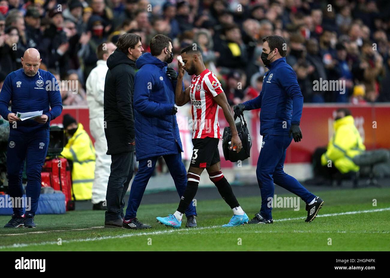 Brentford's Rico Henry leaves the pitch with a head injury after a ...