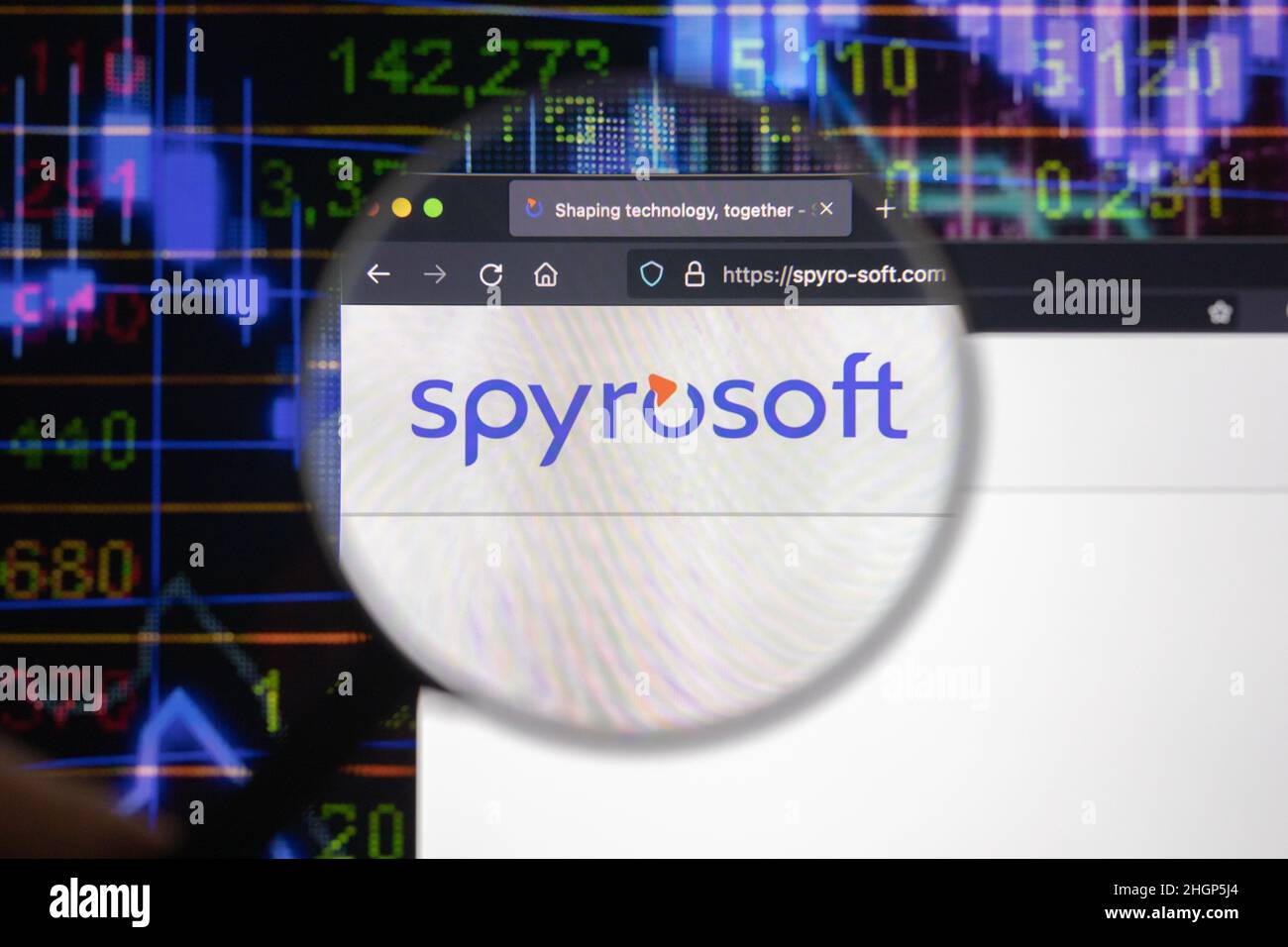 Spyrosoft company logo on a website with blurry stock market ...