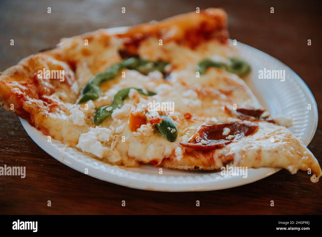 Rustic pizza with salami, mozzarella, olives and basil top view with ...
