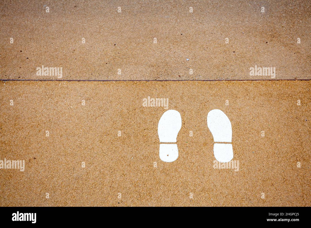footprints on a concrete pavement before crossing Stock Photo - Alamy