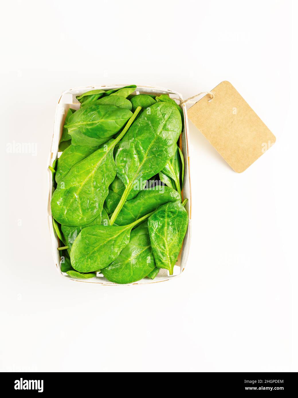 Isolated young organic spinach in an eco friendly tree bark package ...