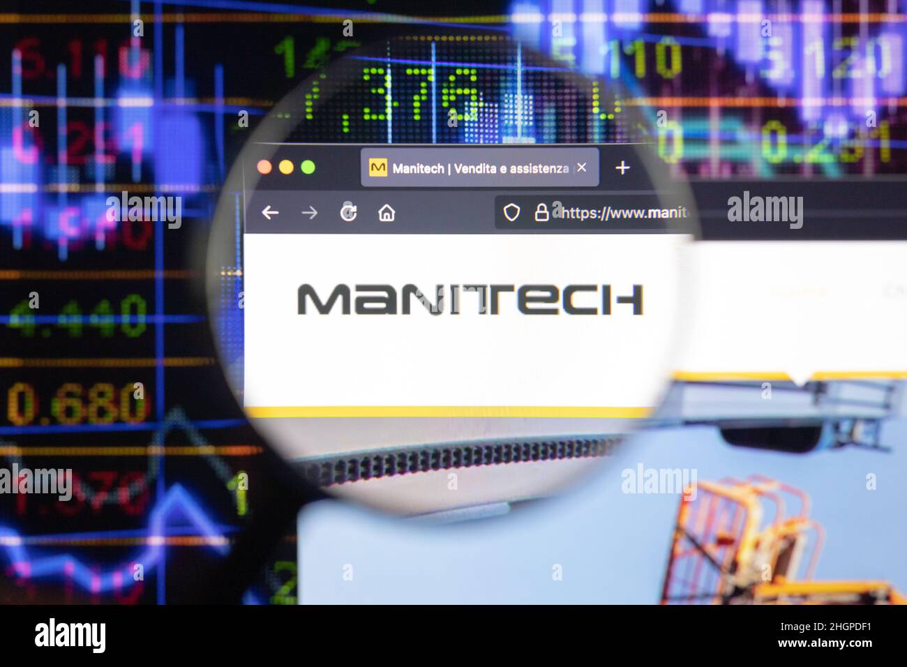 Manitech company logo on a website with blurry stock market ...
