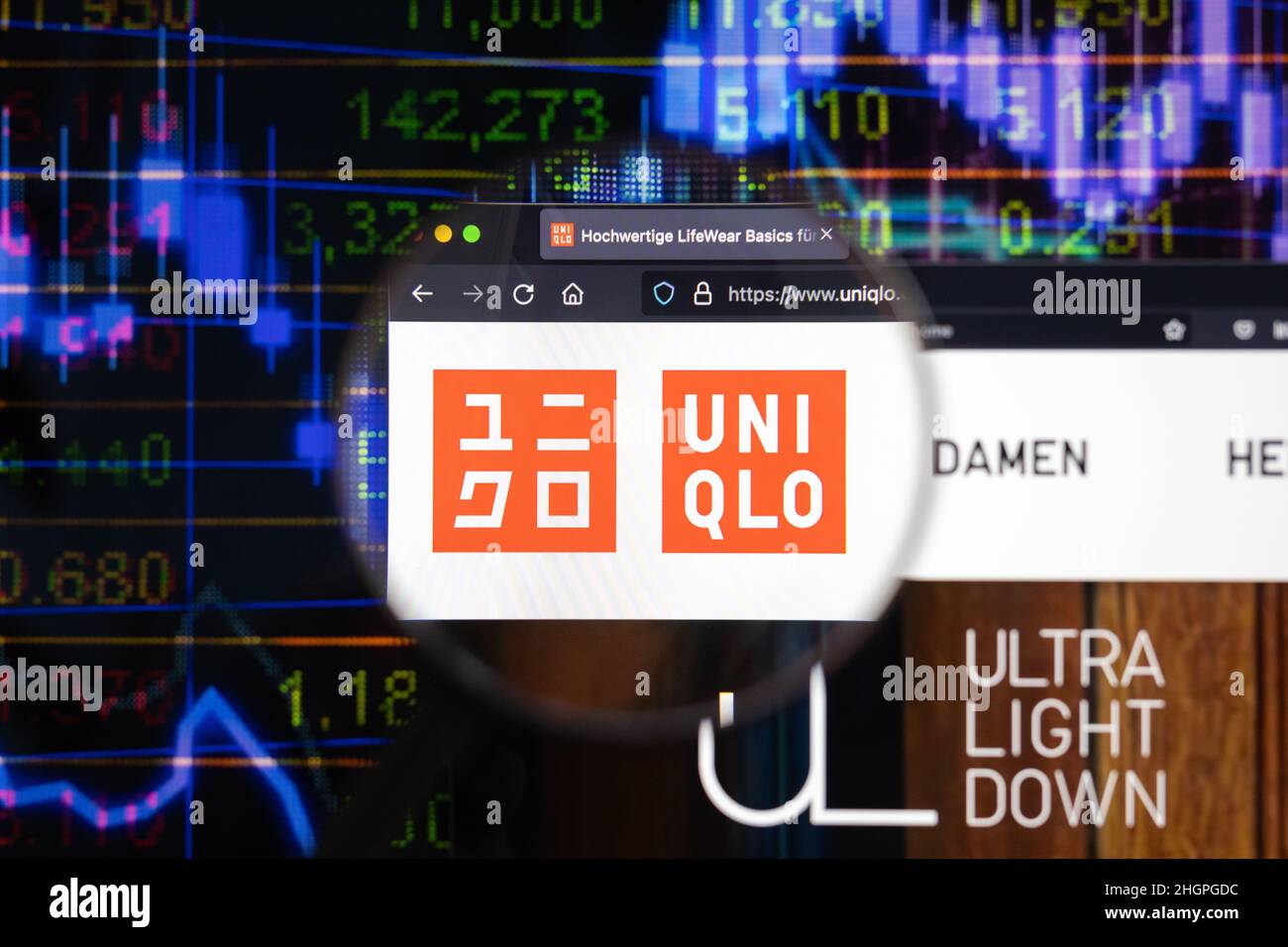 Uniqlo company logo on a website with blurry stock market developments ...