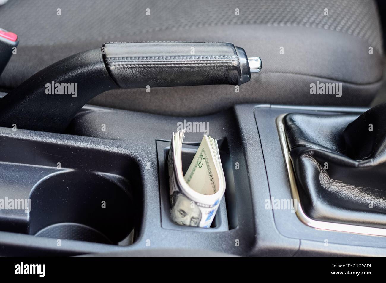A wad of dollars inside the car. A wad of dollars inside the car Stock ...