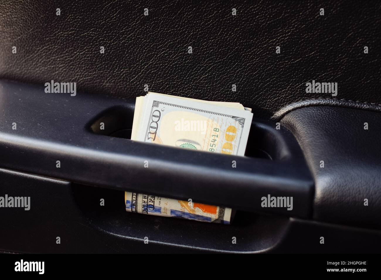 A wad of dollars inside the car. A wad of dollars inside the car Stock ...
