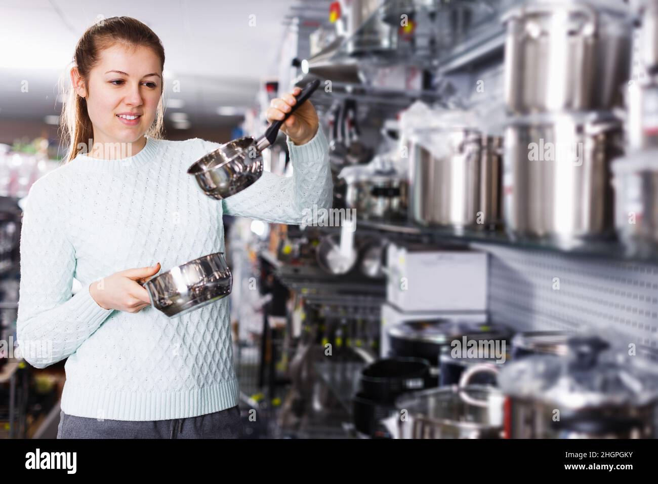 female is buying new drpping pan Stock Photo - Alamy