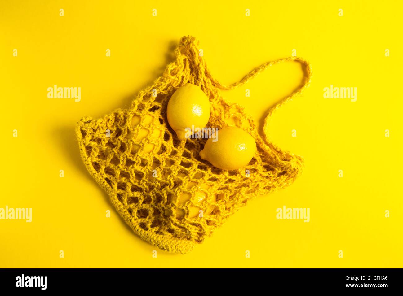 Juicy lemons on a bright yellow background, citrus minimal concept ...