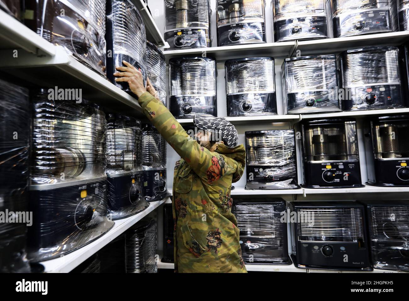 Baghdad, Iraq. 22nd Jan, 2022. An Iraqi salesman displays oil heaters ...