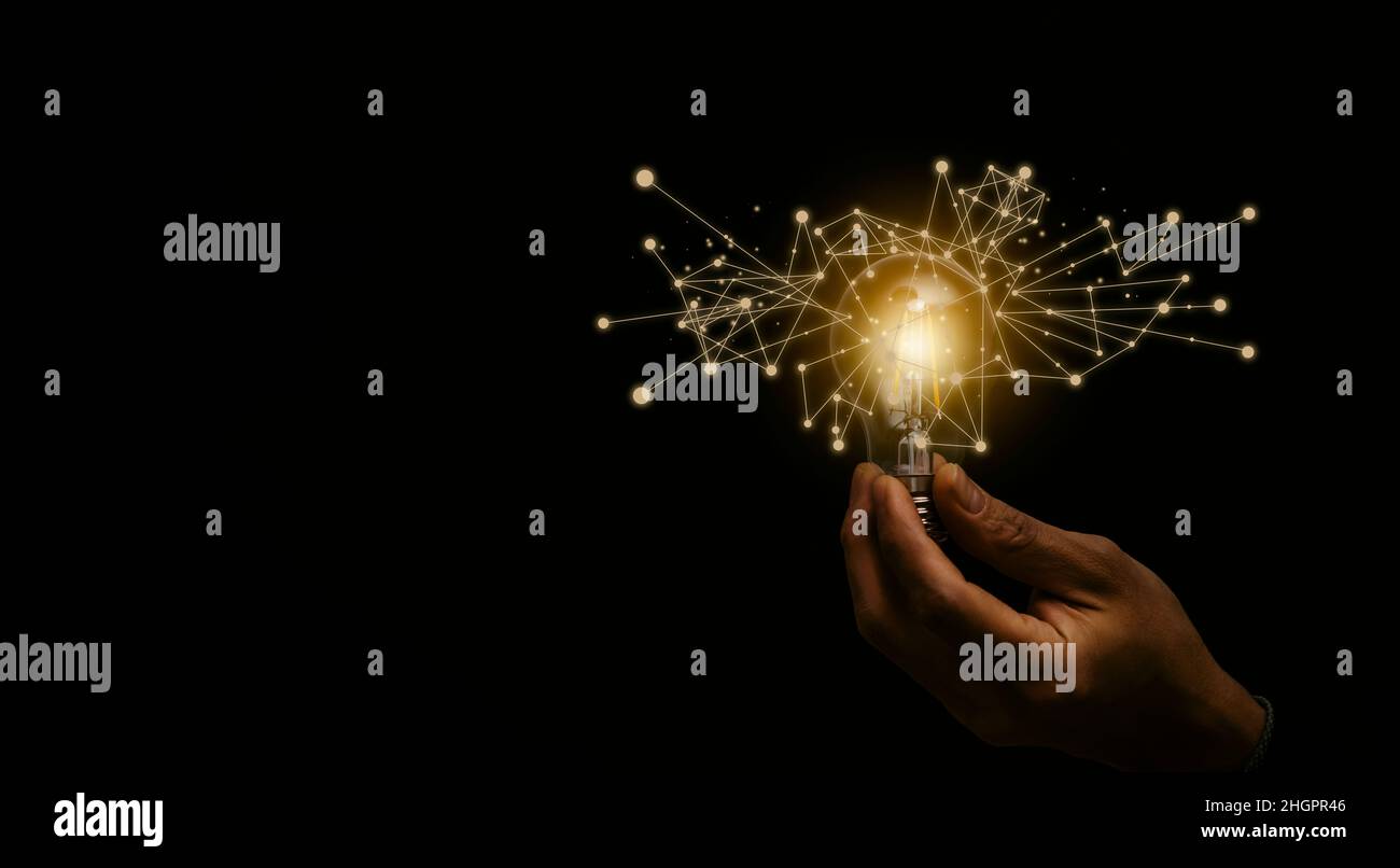 Hand holding illuminated light bulb, idea, innovation and inspiration concept.concept of ...