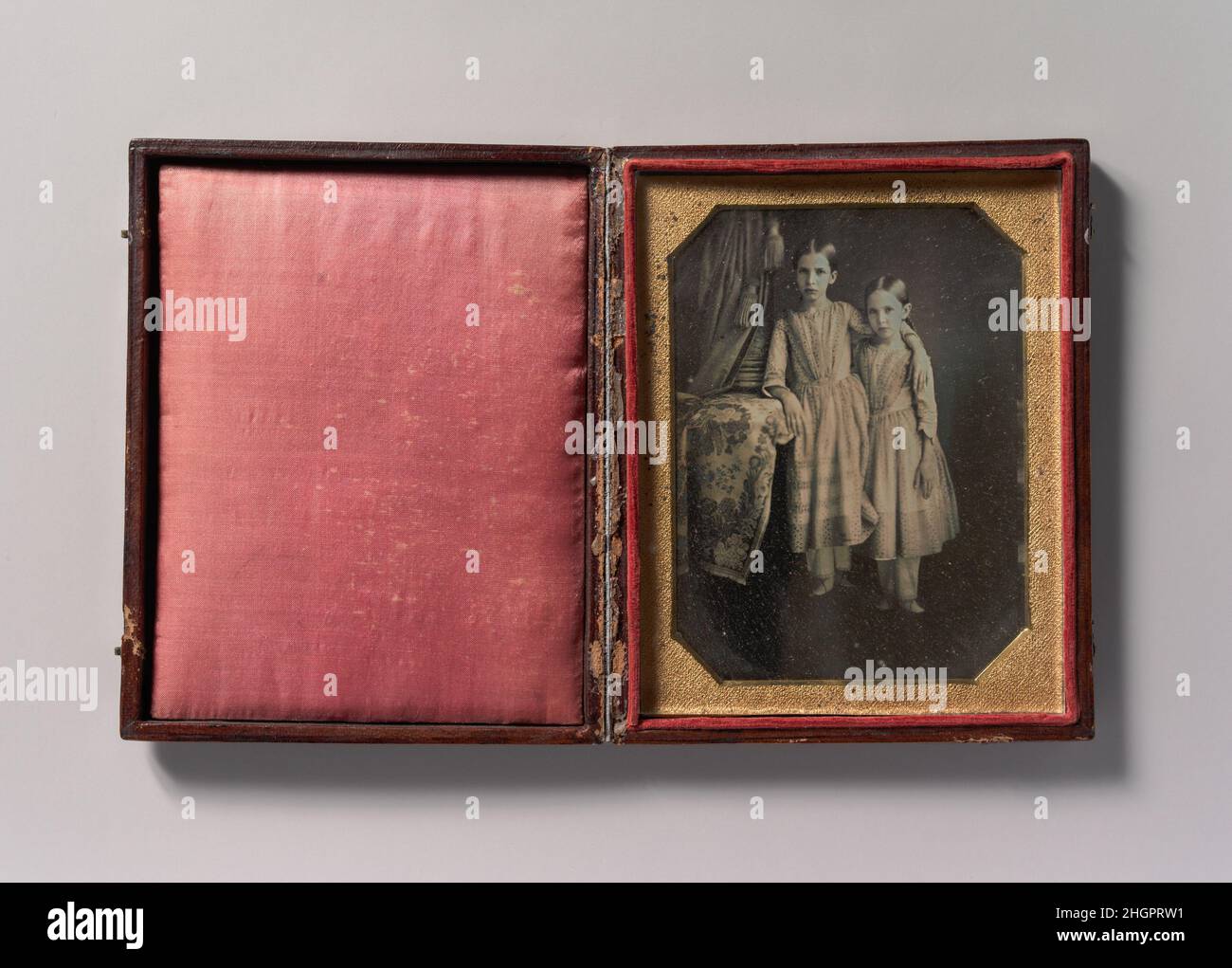 [Two Identically Dressed Young Girls Standing Next to a Table] 1840s ...
