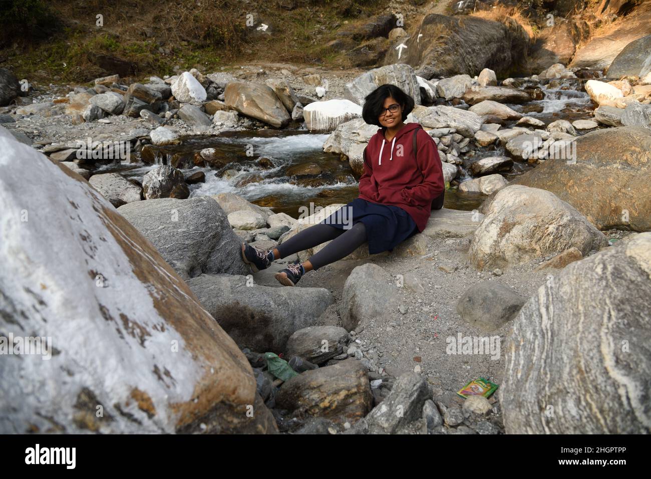 Smiling young adult Indian woman poses on the riverbed Chel at ... Smiling young adult Indian woman poses on the riverbed Chel at ...