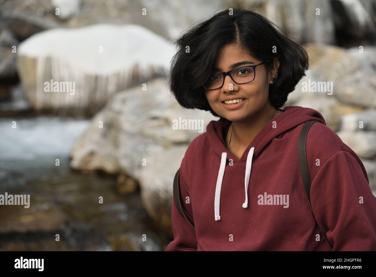 Smiling young adult Indian woman poses on the riverbed Chel at ... Smiling young adult Indian woman poses on the riverbed Chel at ...