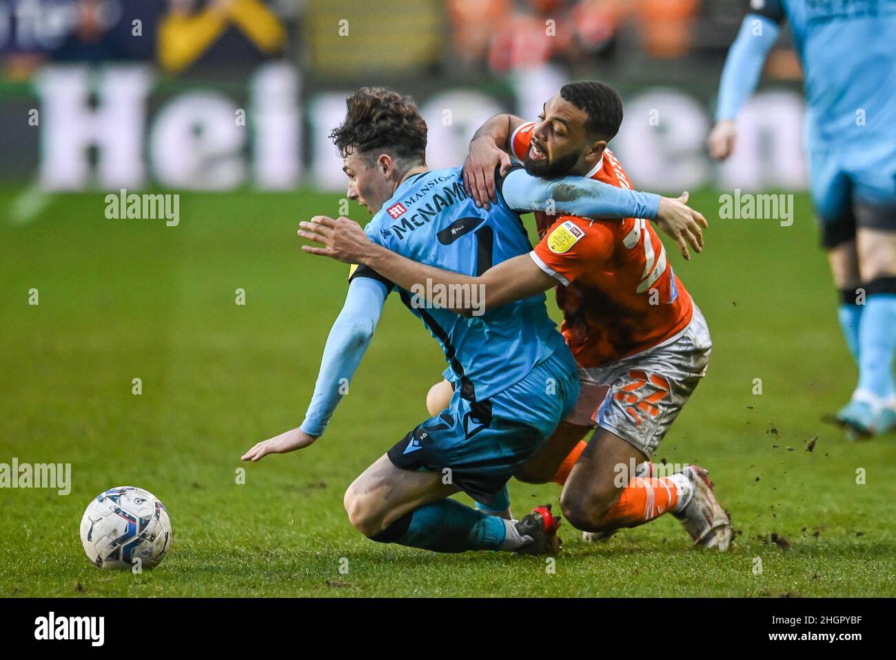 CJ Hamilton #22 of Blackpool is fouled by Dan McNamara #2 of Millwall ...