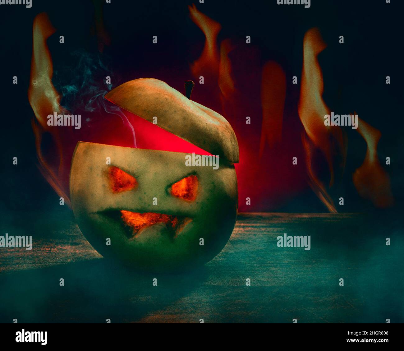 Fine art depicting a carved apple with a scary face with flames behind ...