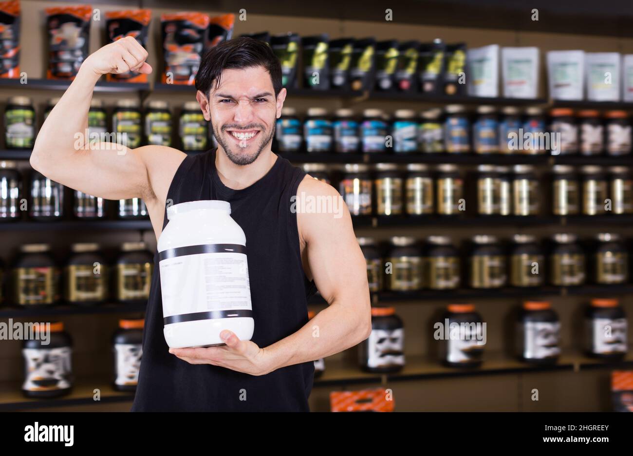 Young muscular man showing his biceps Stock Photo - Alamy