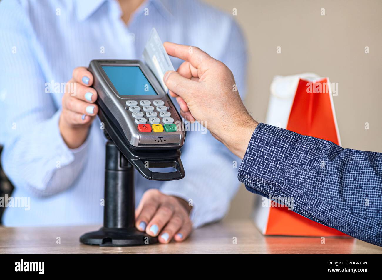 A man makes online purchases using a mobile terminal. Swipes a plastic ...