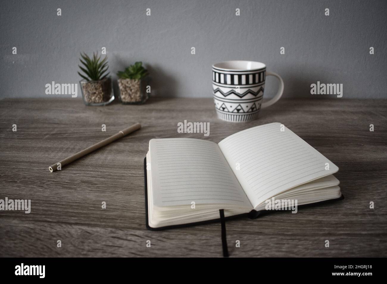 Open notebook with a pen on a desk Stock Photo - Alamy