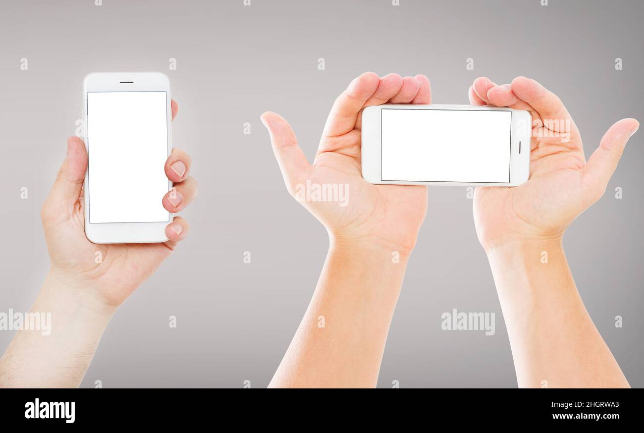set hands holding empty blank screen mobile phones isolated on gray ...