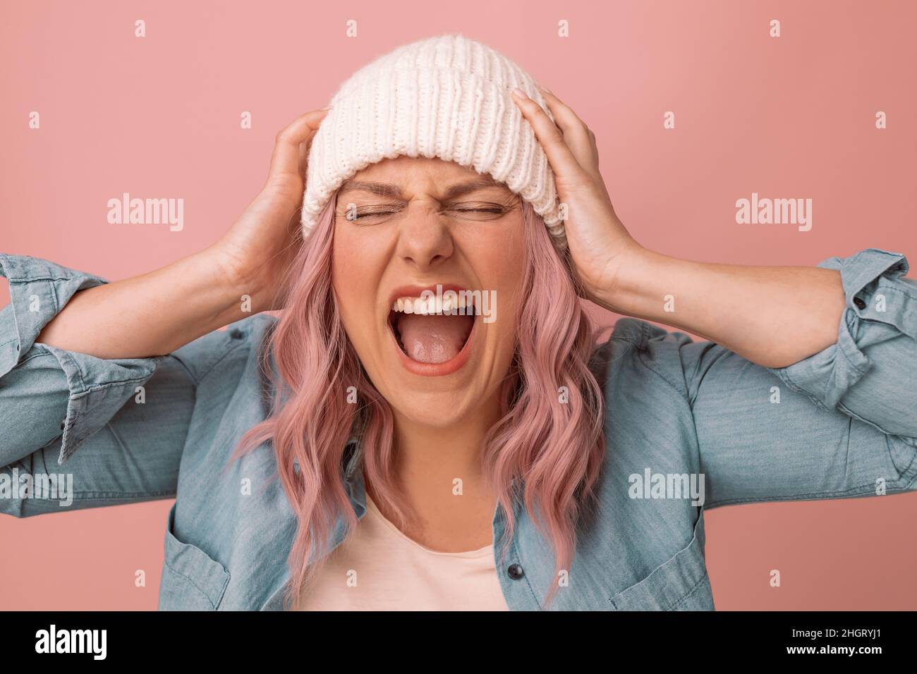 Closeup portrait of young emotion angry woman screaming on pink ...