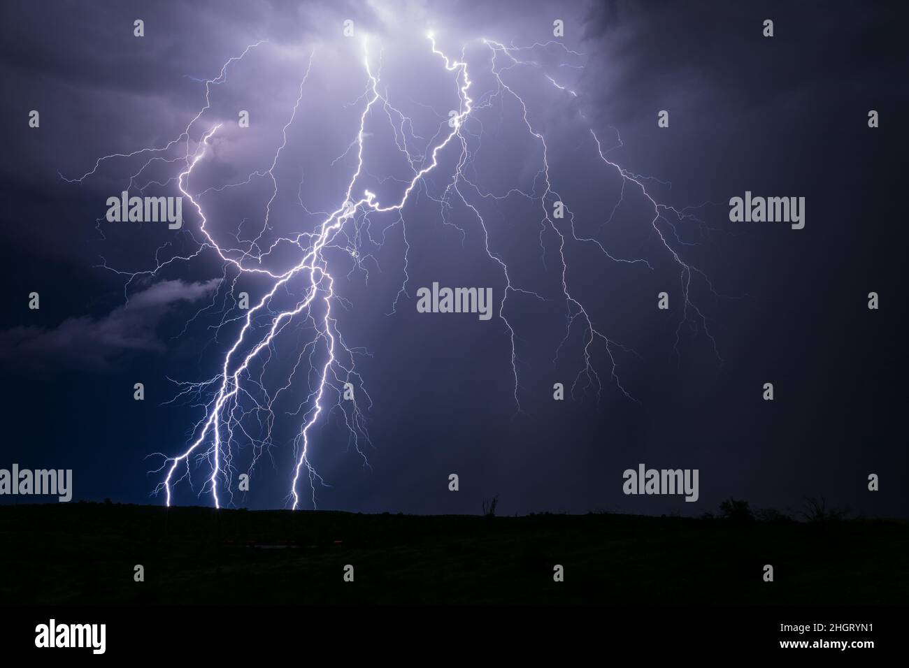 A massive lightning strike from a monsoon thunderstorm in the desert ...