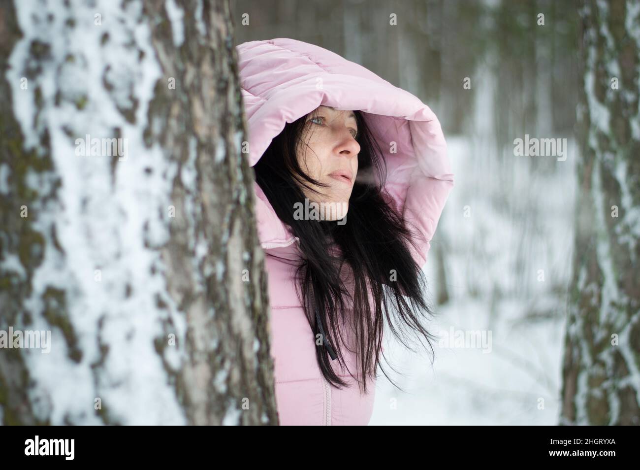 Woman hiking in the woods and smoking an e-cigarette. Vaping smoke ...