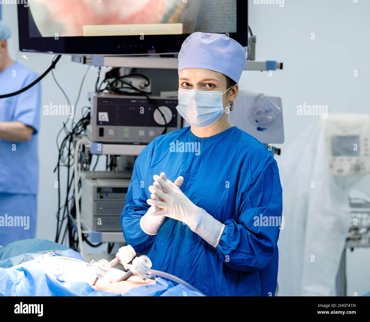 A female surgeon in sterile gloves and a surgical uniform in the ...