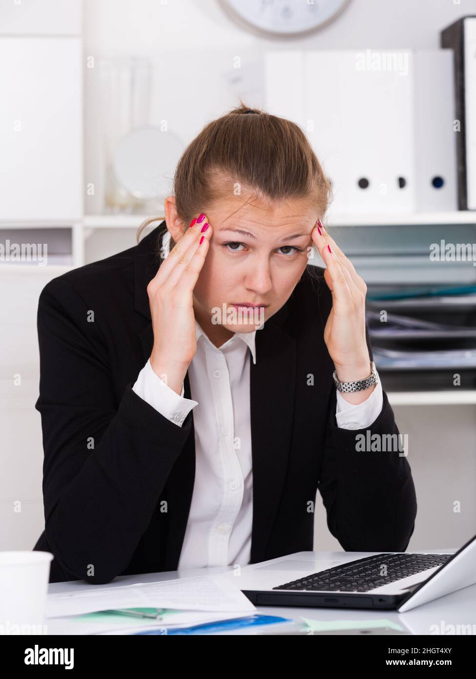 Female manager in black suit is having complicated issue with project ...