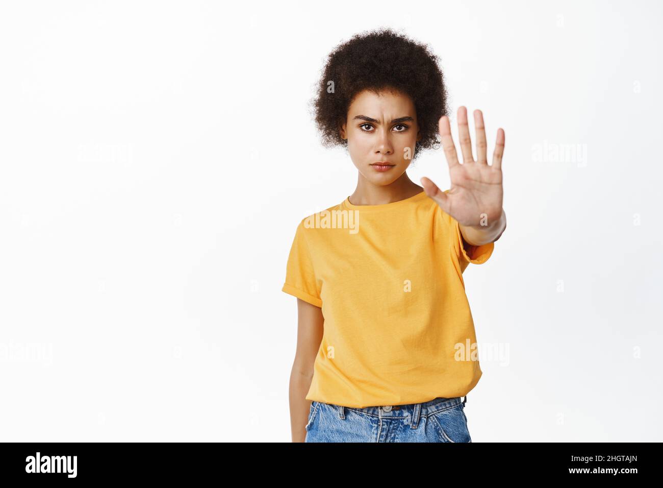 Stop this, stay away. Serious and confident Black girl extend palm ...