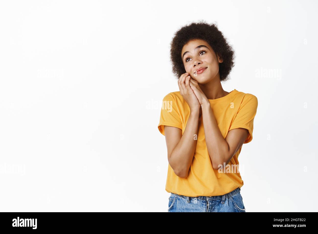 Portrait of romantic dreamy african woman, gazing up with thoughtful ...