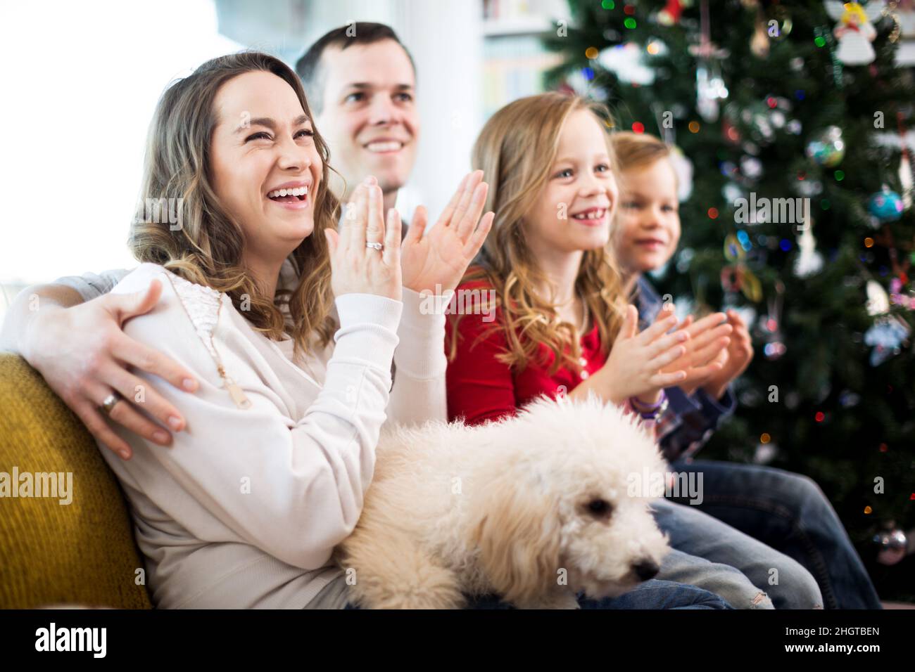 Parents and children happy to spend Christmas together Stock Photo - Alamy