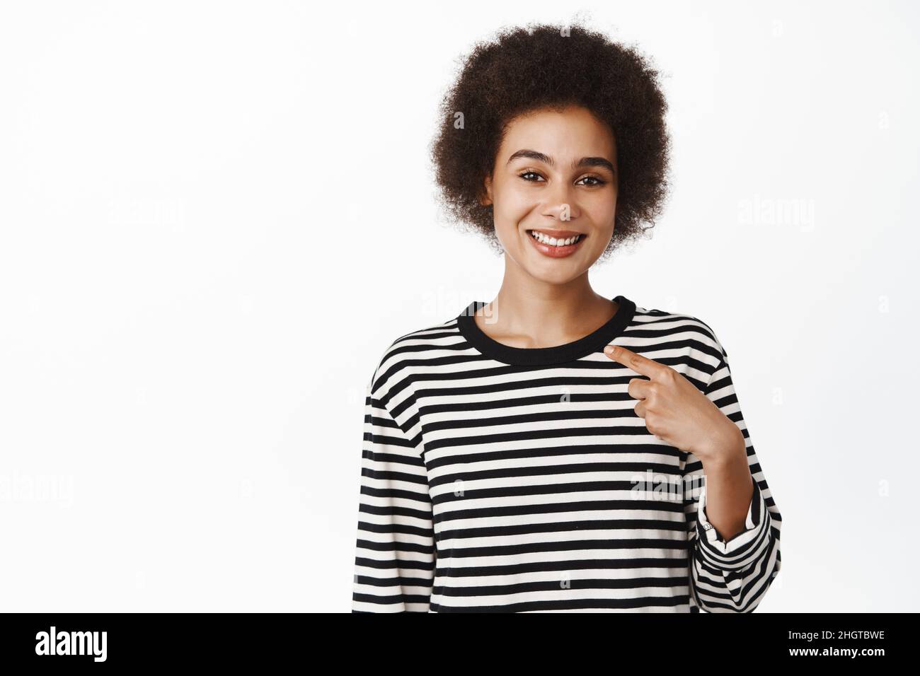 Close up portrait of black girl student smiling, pointing finger at ...