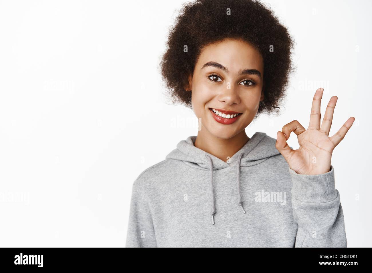 Portrait of cheerful black girl showing okay, zero no problem gesture ...