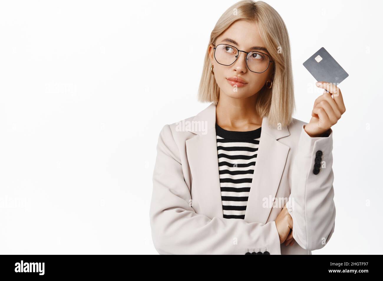 Image of business woman with thoughtful face looking away, holding ...
