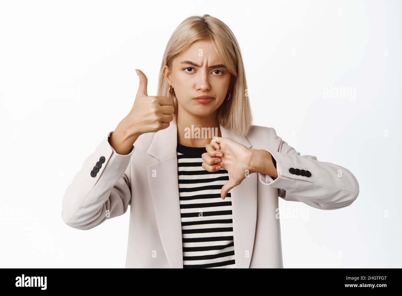 Decisions. Young businesswoman, office girl makes choice, shows thumbs ...