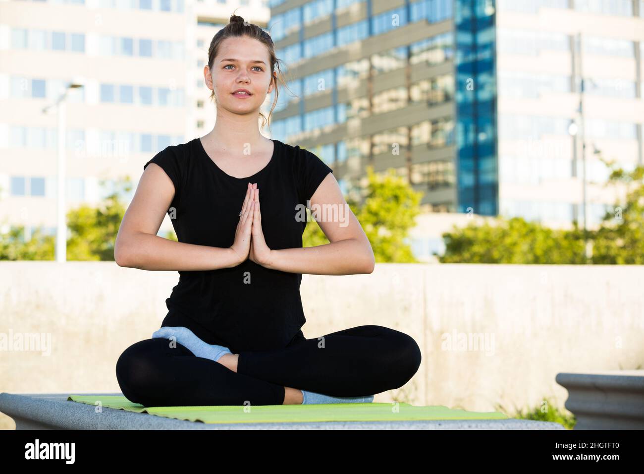 Girl in lotus positions outdoors Stock Photo - Alamy