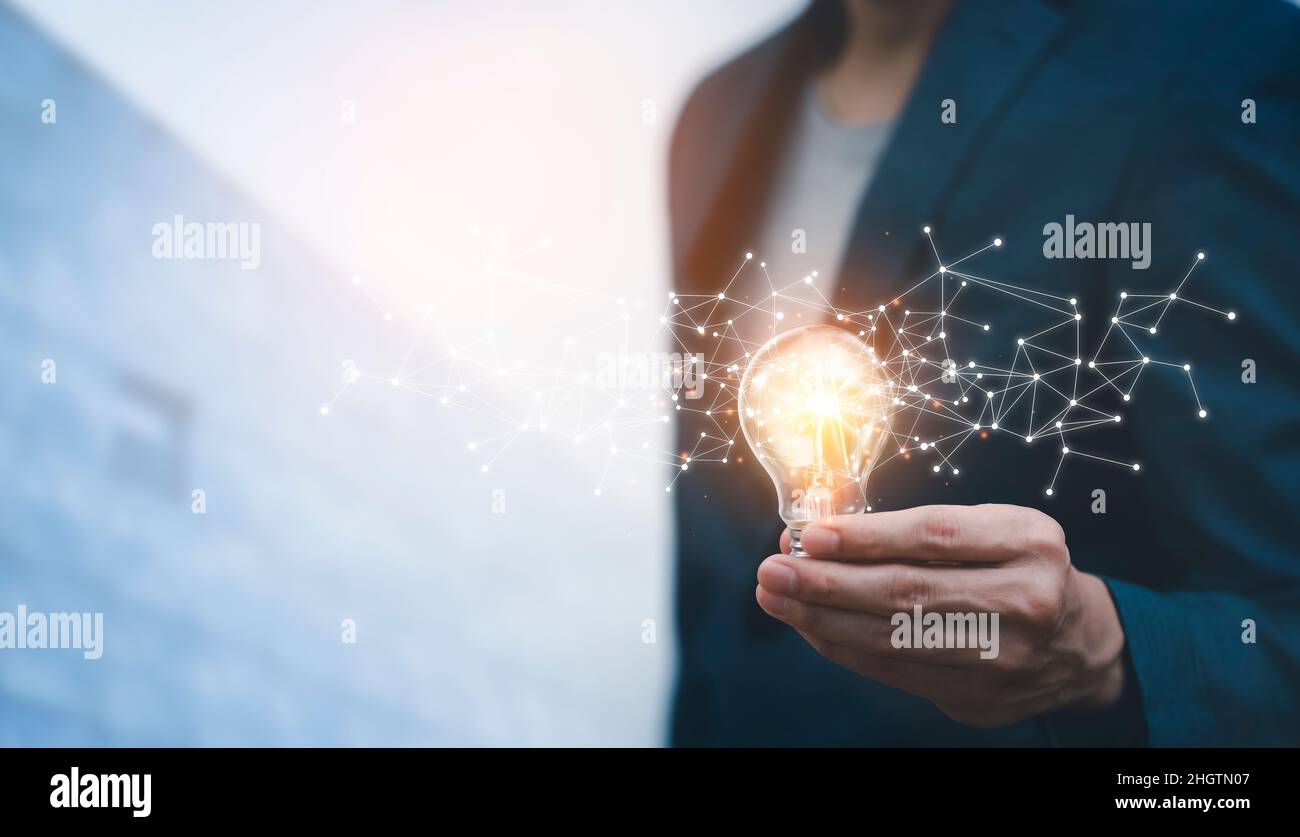 business hand holding illuminated light bulb, idea, innovation and inspiration concept.concept ...