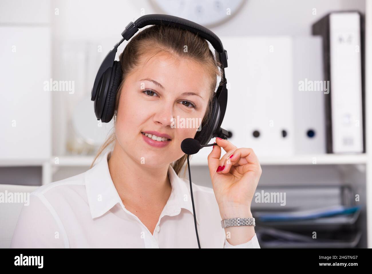 Portrait of young female which is talking with client Stock Photo - Alamy
