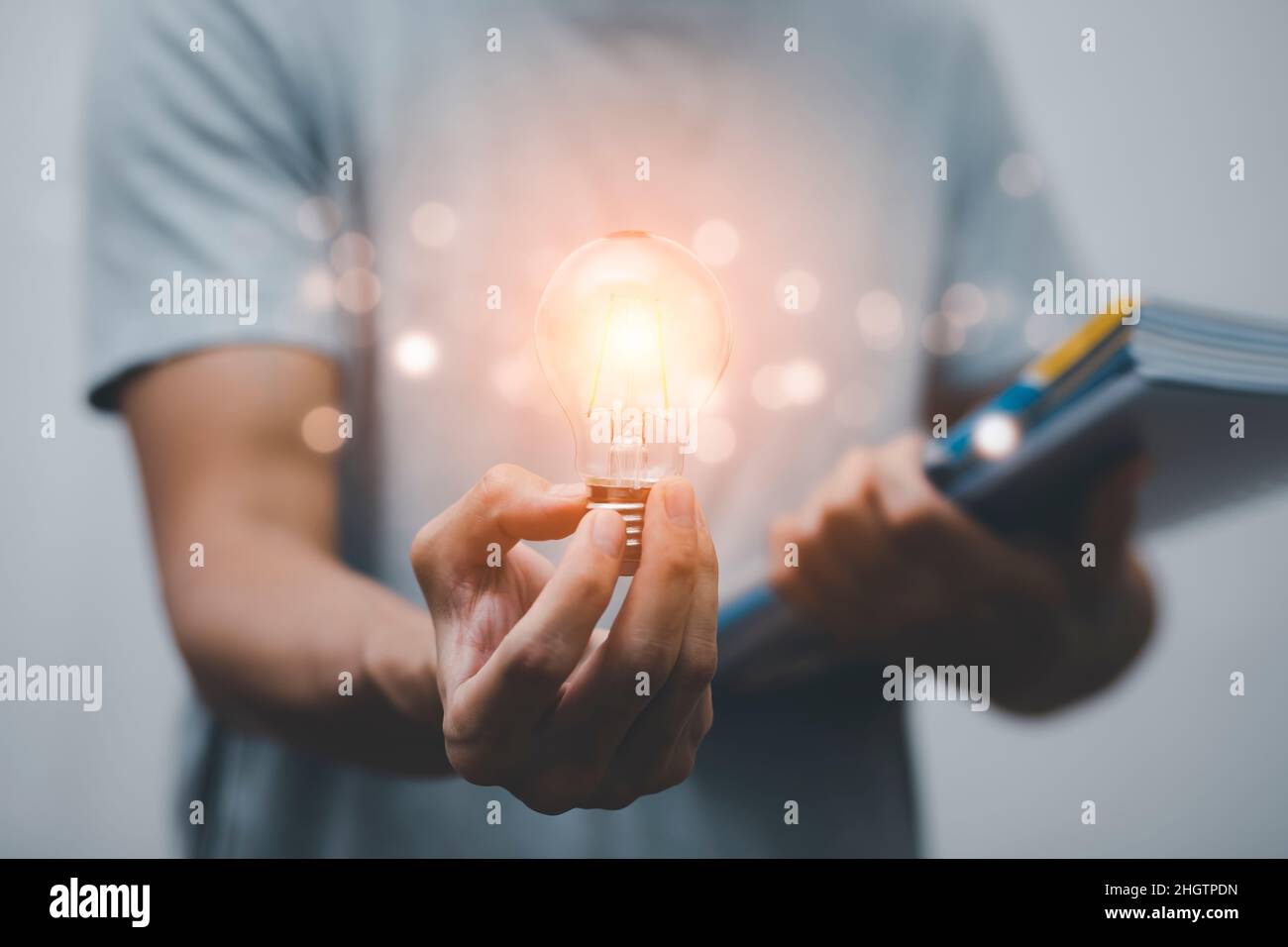 Concept creativity with light bulbs and energy power, Man hand holding ...