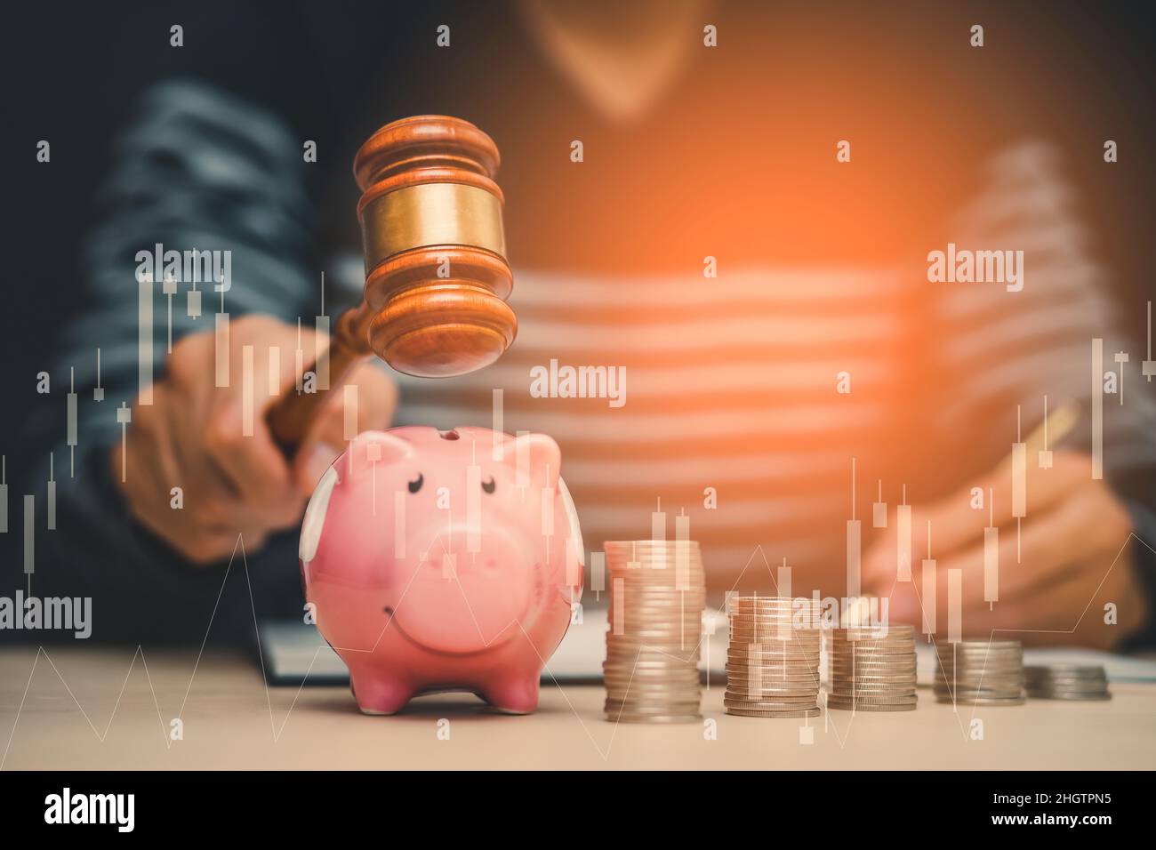 Old wood Judge hammer with Happy Pink piggy Bank in close-up and coins ...