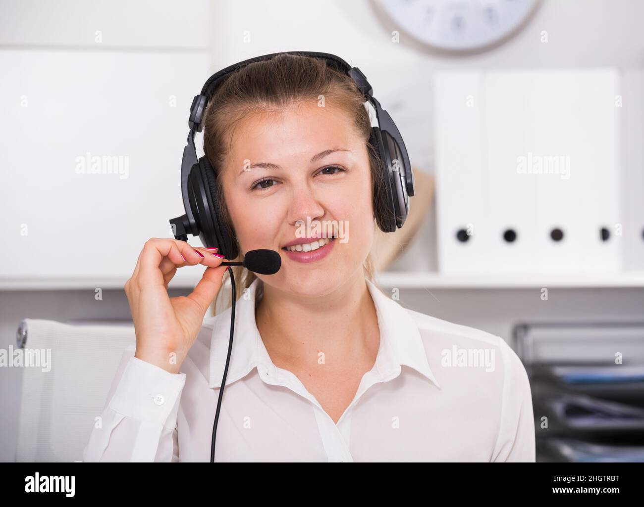 Portrait of operator woman which is talking with client Stock Photo - Alamy