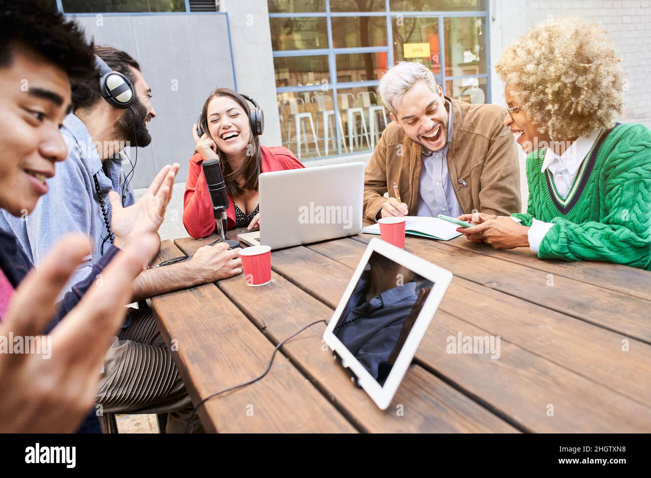 Audio broadcast outdoors. Happy laughing young people smiling podcast ...
