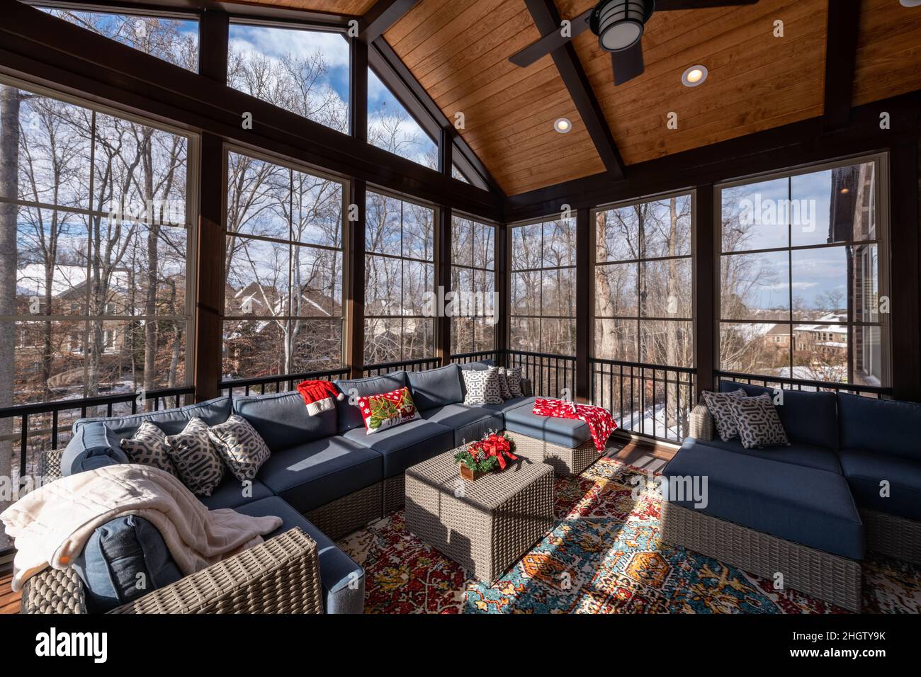 Cozy screened porch winter during Holidays season, snowy roofs and ...