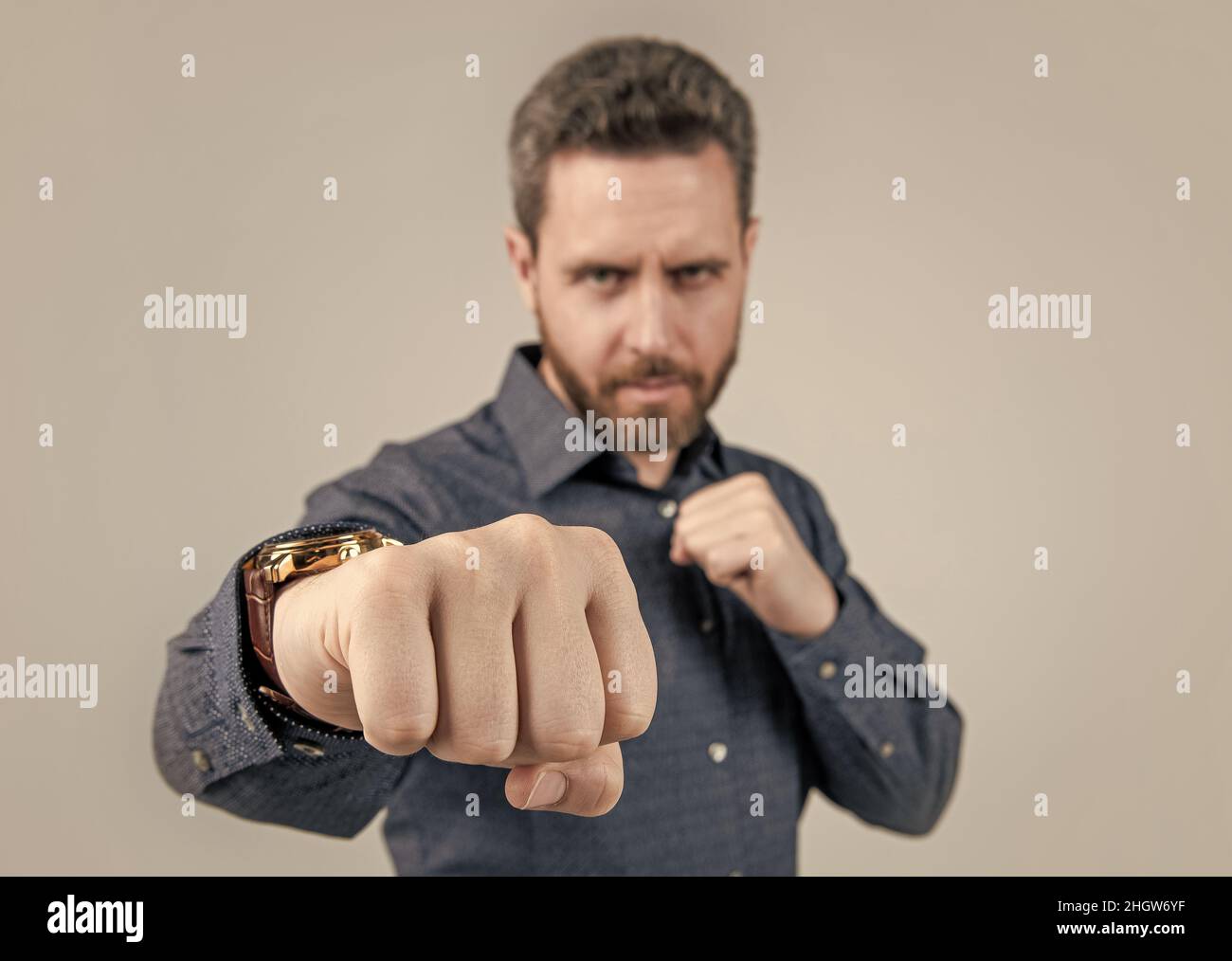 Mature man stand in offensive fighting position with clenched fist ...