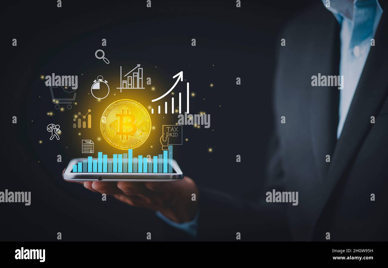 Smartphone with Bitcoin chart on-screen among piles of Bitcoin concept ...