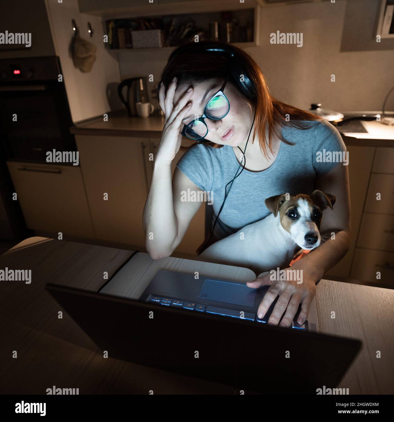 Woman thinking over laptop night hi-res stock photography and images ...