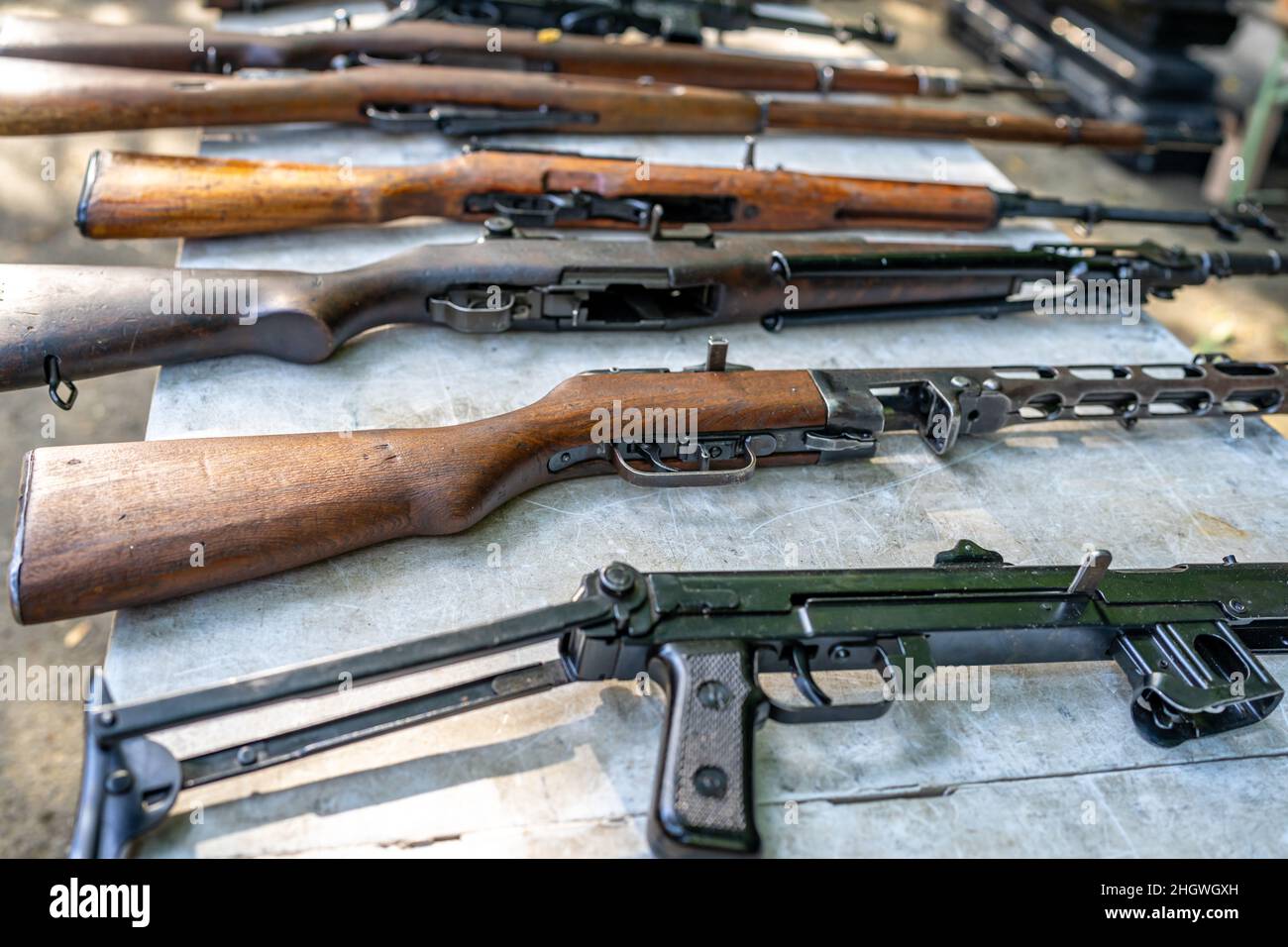 collection of historical and modern weapons on the shooting range Stock ...