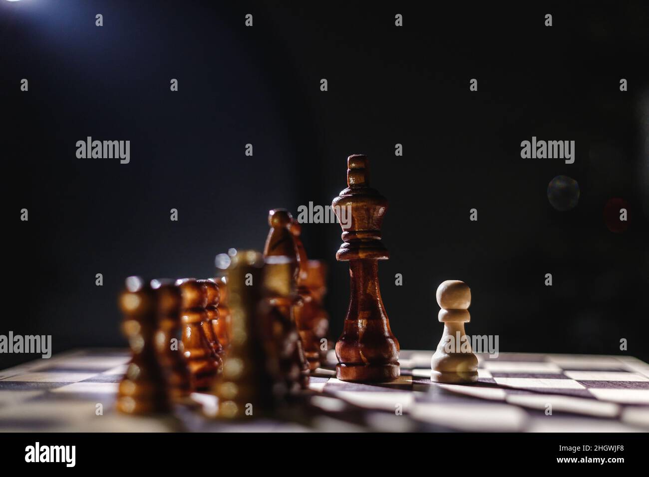 One pawn staying against full set of black chess pieces. One against ...