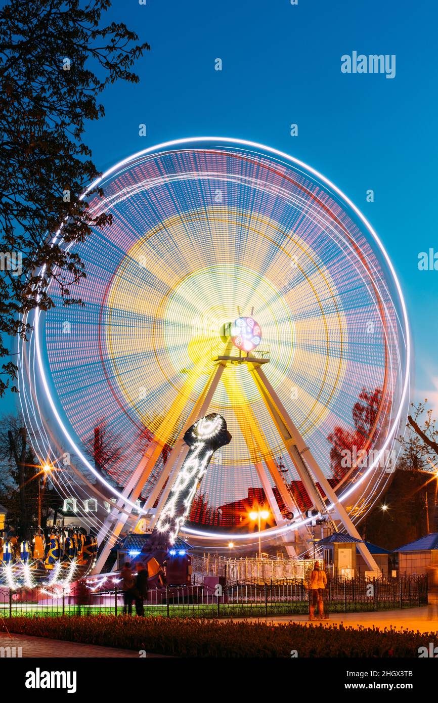 Illuminated Attraction Ferris Wheel On Summer Evening In City Amusement ...